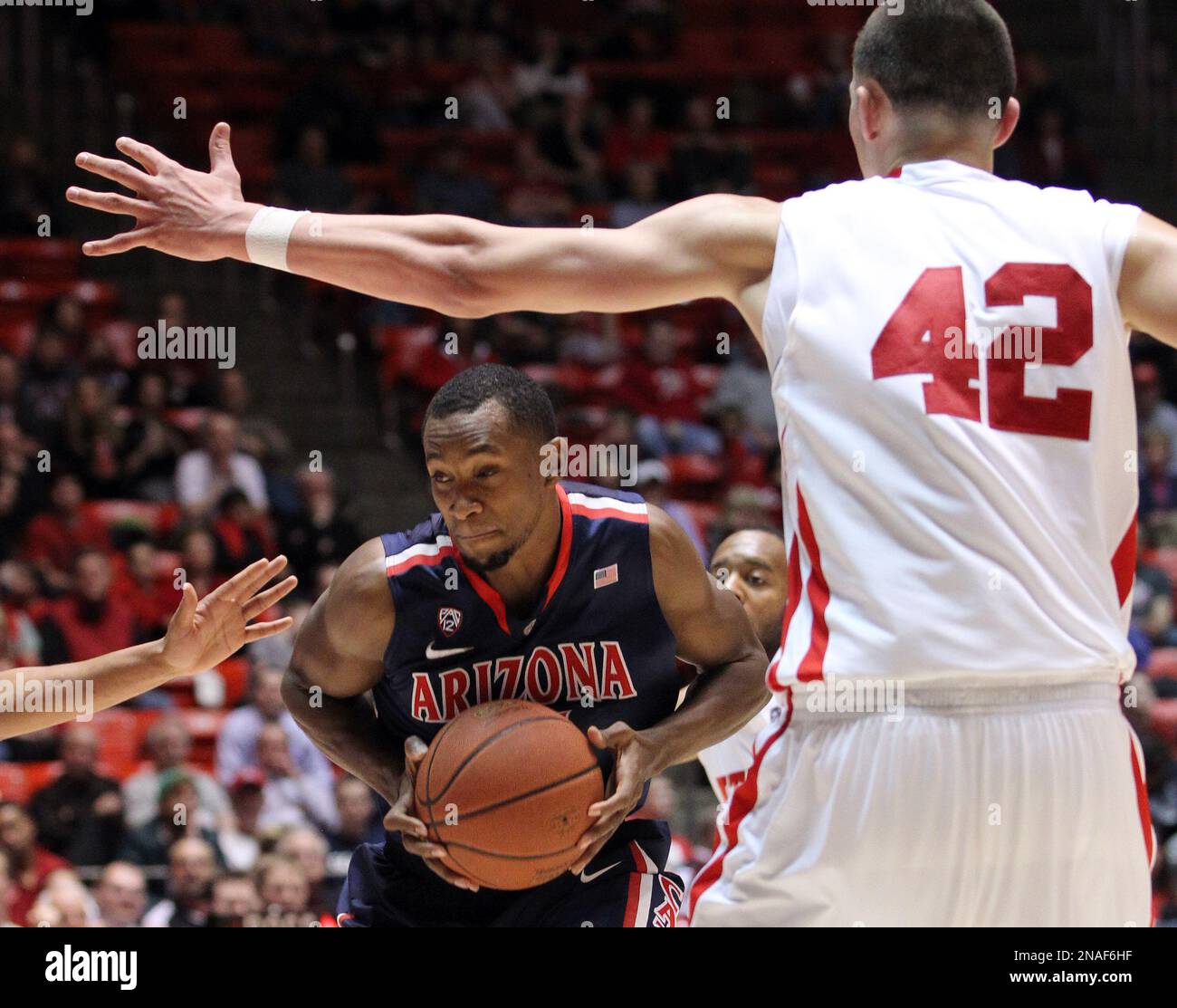 Arizona guard Kyle Fogg (21) is pressured by Utah center Jason Washburn ...