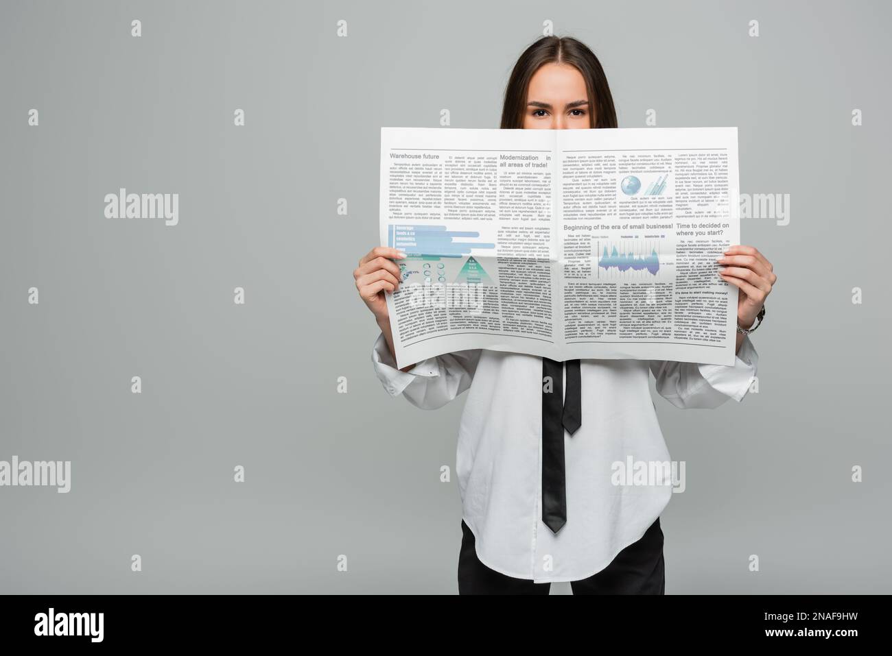 Young woman covering face newspaper hi-res stock photography and images ...