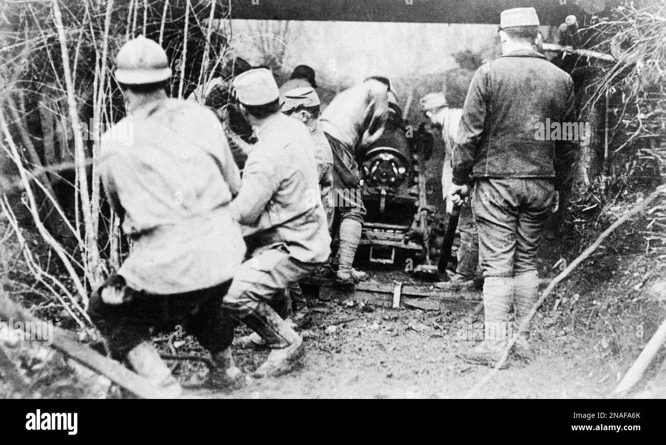 French troops prepare to fire a big howitzer from the Meuse heights ...