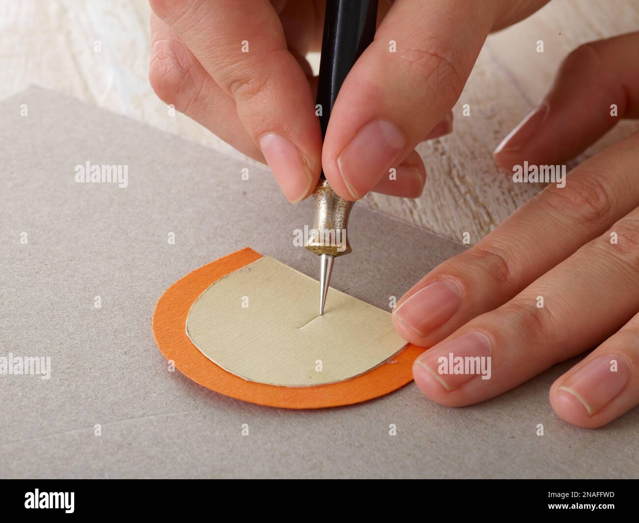 Papercraft. DIY animal mask. Step 6, scorng line into ear Stock Photo ...