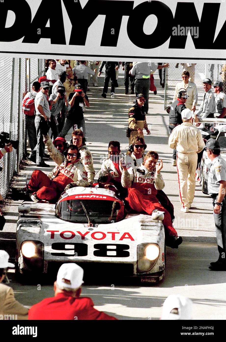 The crew of a Toyota MK111 ride on top of a car driven by P.J. Jones ...
