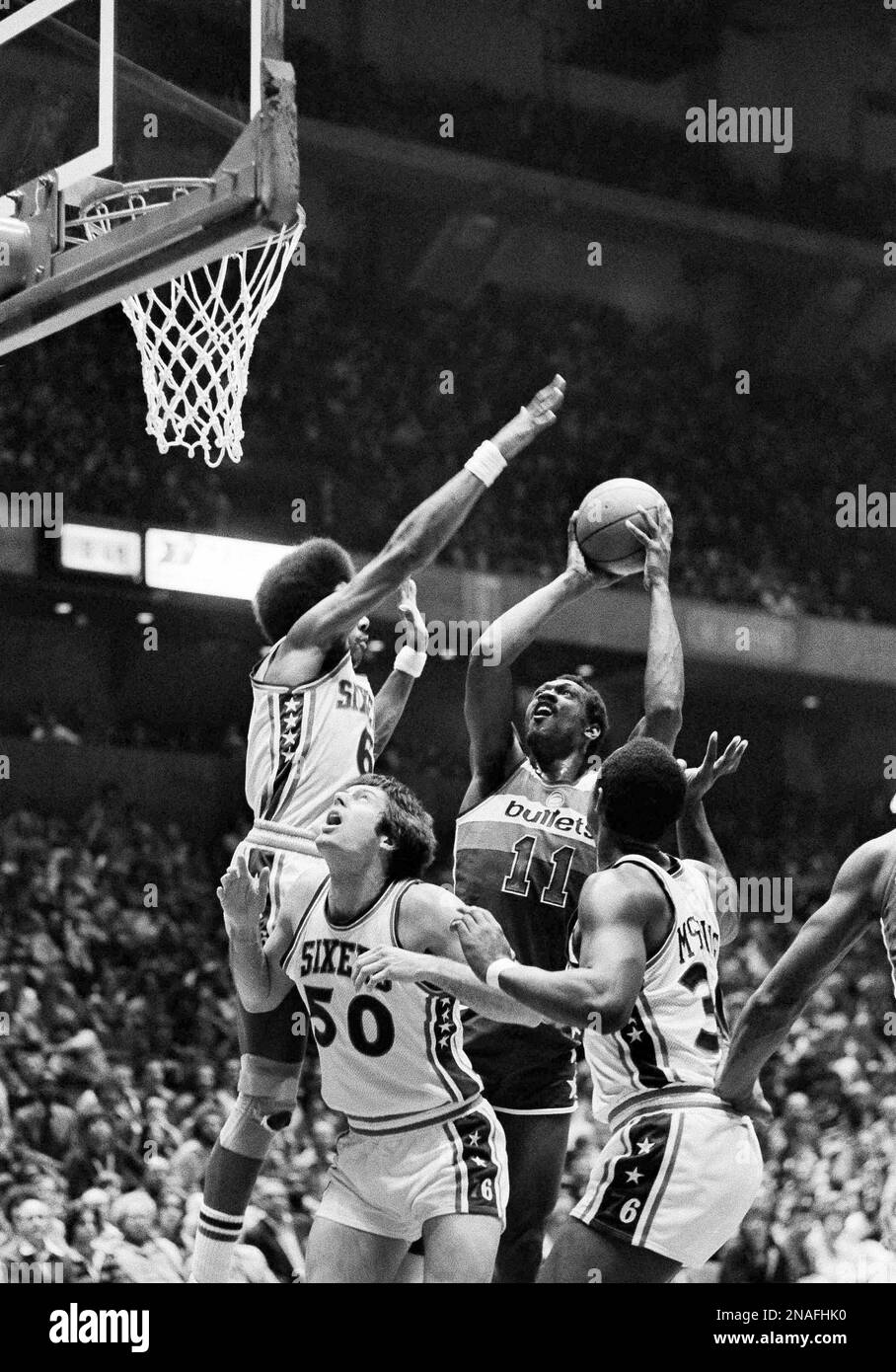 Washington Bullets' Elvin Hayes goes up for a shot between 76ers ...