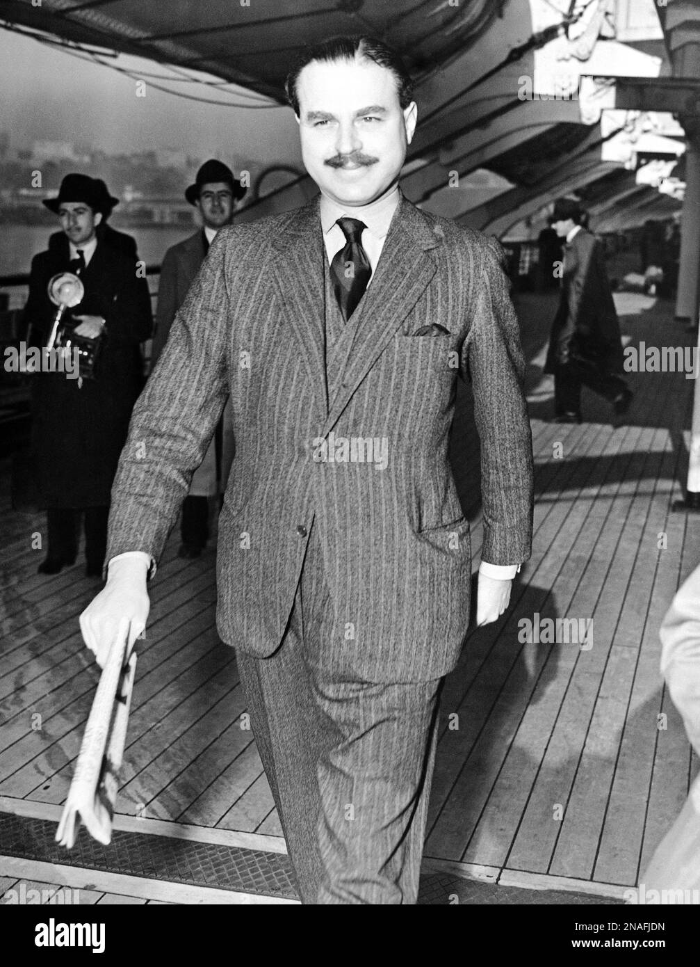 Ernest Simpson, left, seen with a press photographer beside him after ...