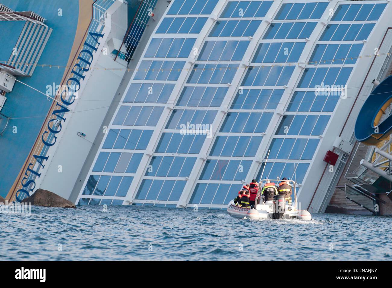 The cruise ship Costa Concordia leans on its side off the tiny Tuscan ...