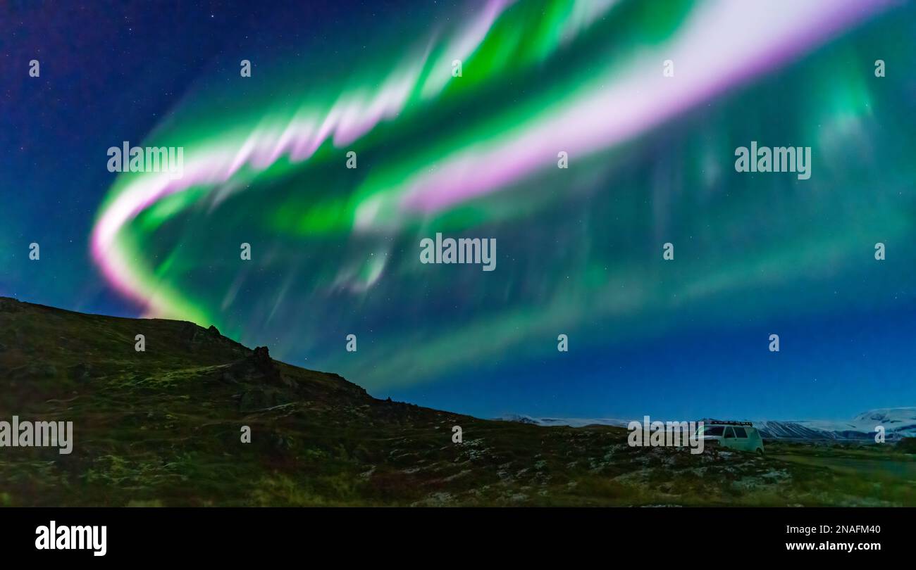Curved purple and green beams over the sky, northern lights Stock Photo ...