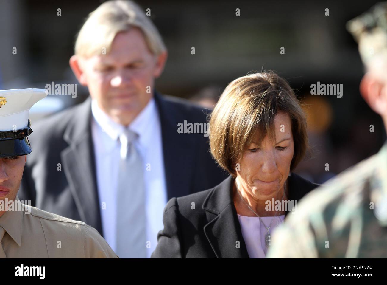 James Hogan, back right, and his wife, Carla Hogan, are escorted by ...