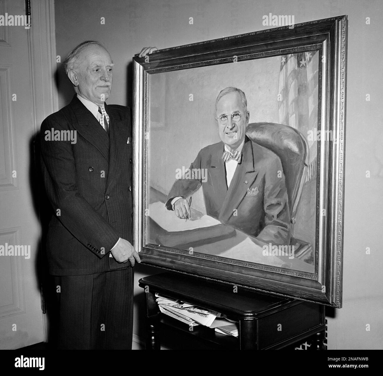 Carl Bohnen, Hollywood, Calif., artist stands next to his portrait of ...