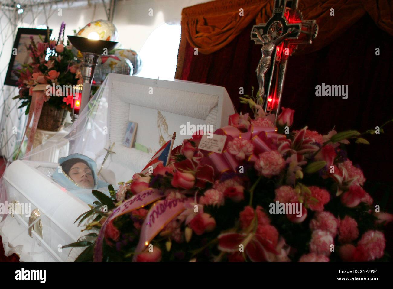 The body of 15-year-old Karla Michelle Negron lies in an open casket ...