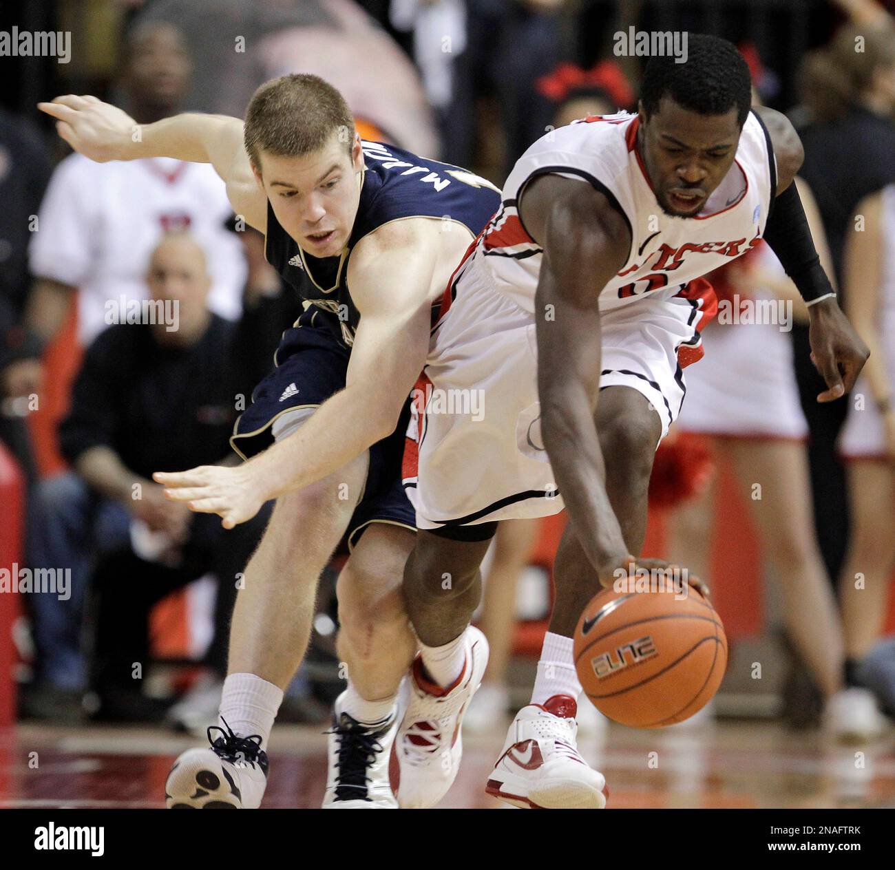 Rutgers' Eli Carter, right, and Notre Dame's Scott Martin reach for the ...