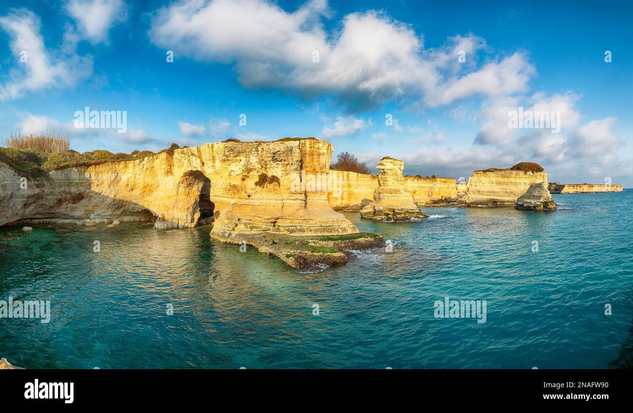 Stunning seascape with cliffs rocky arch and stacks (faraglioni) at ...