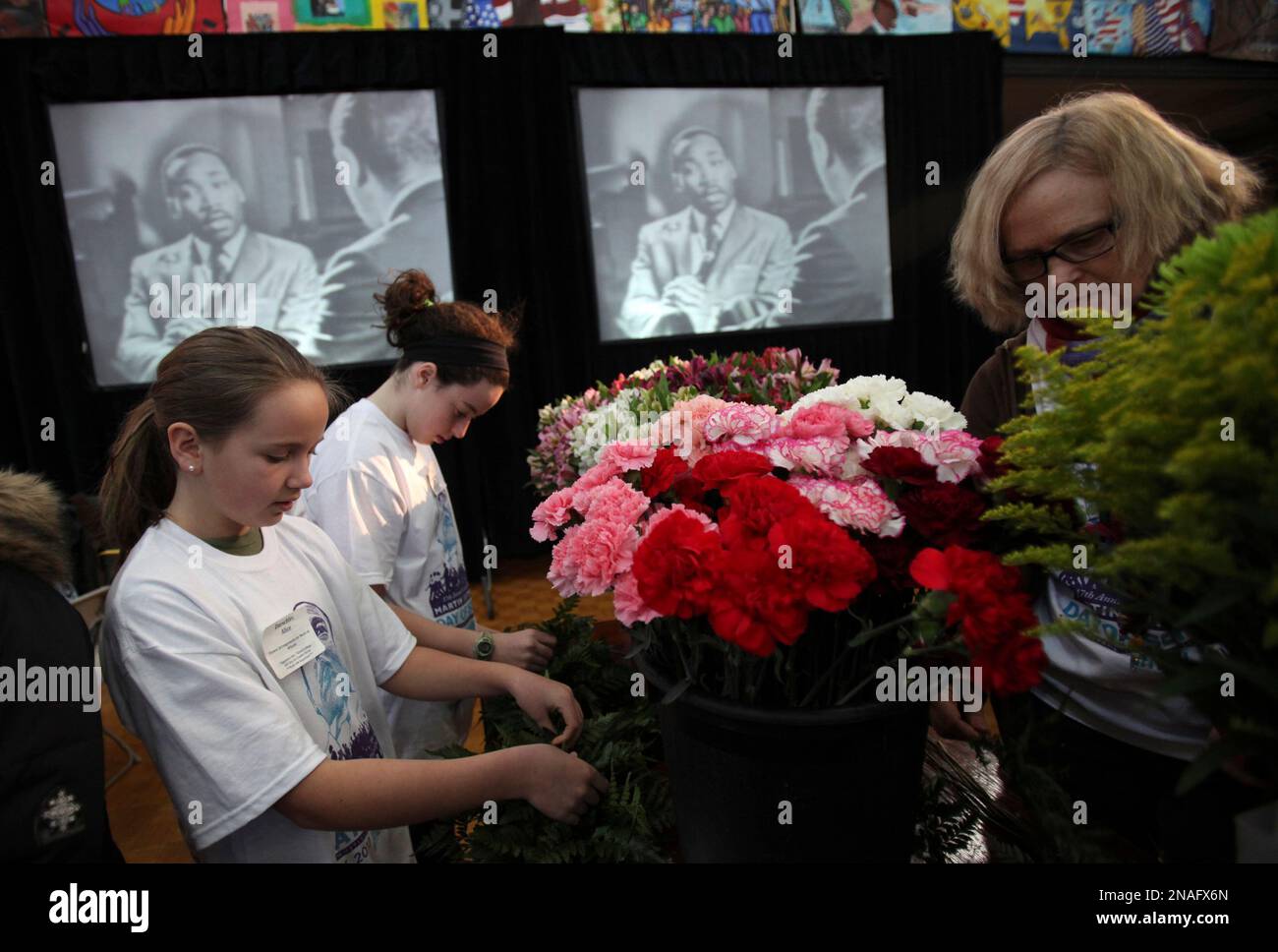Volunteers Alice Daeschler, 12, left, Lily Zukin, 12, center, and ...