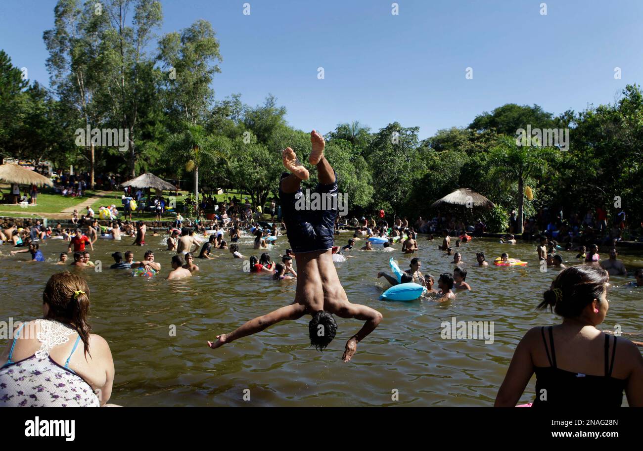 A boy jumps into the swimming pool at the "Paraiso Escondido" spa near ...