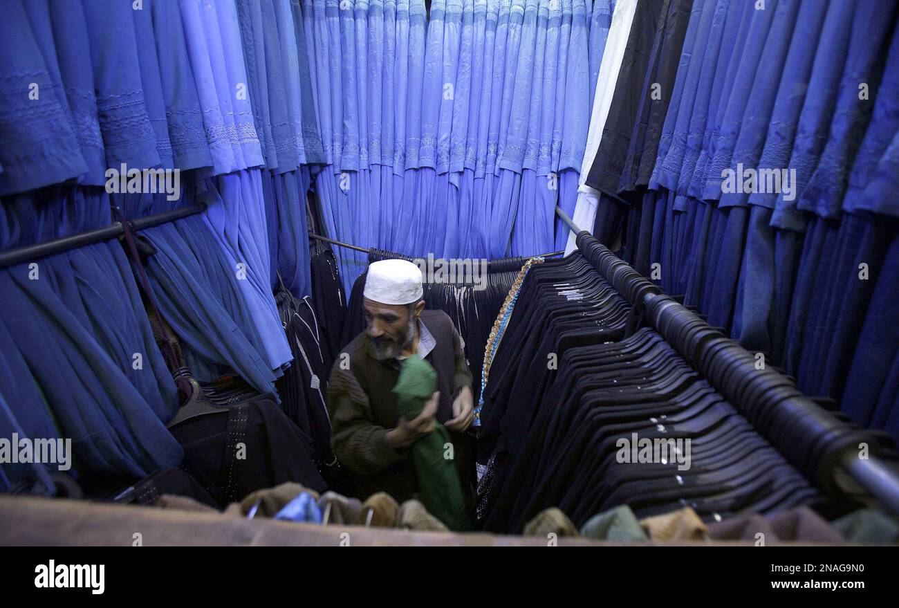 A Pakistani vendor arranges traditional Pashtun 'Burqa' at a shop in ...