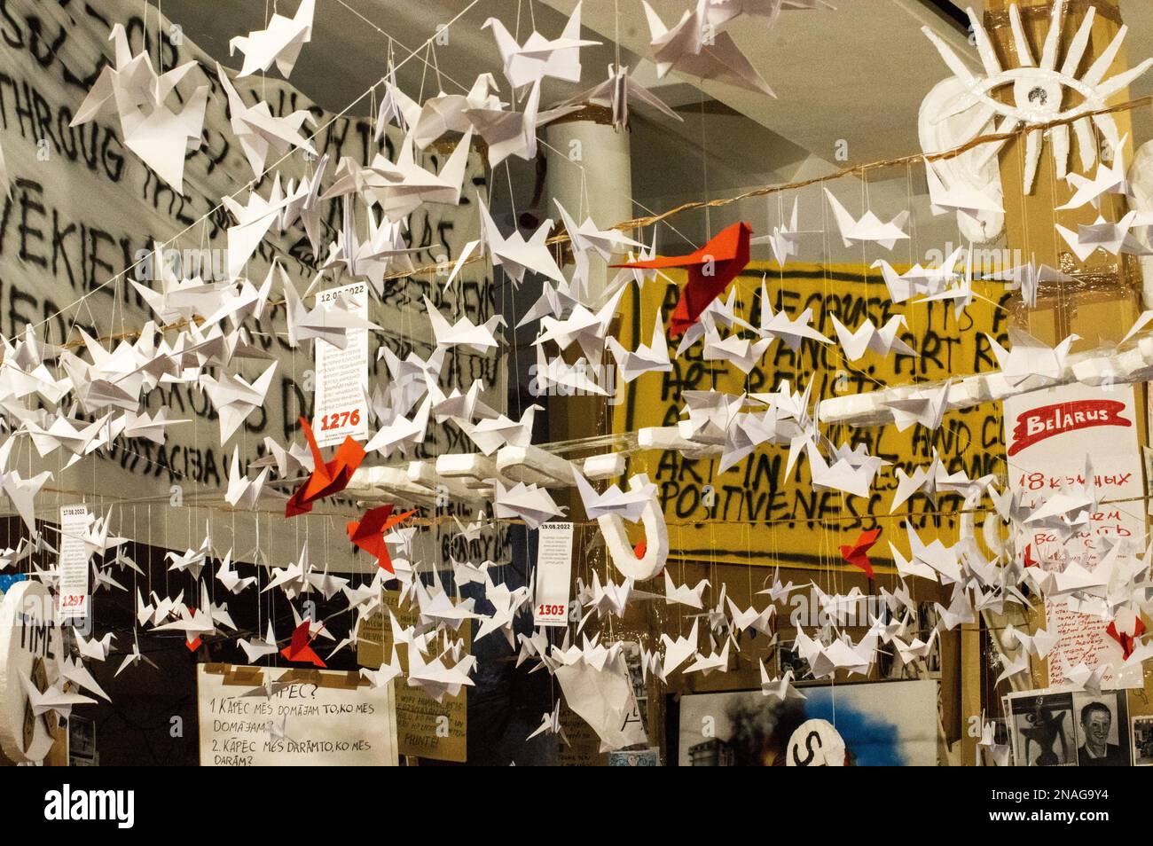 Japanese folded Origami cranes hanging on with strings. Hundreds ...