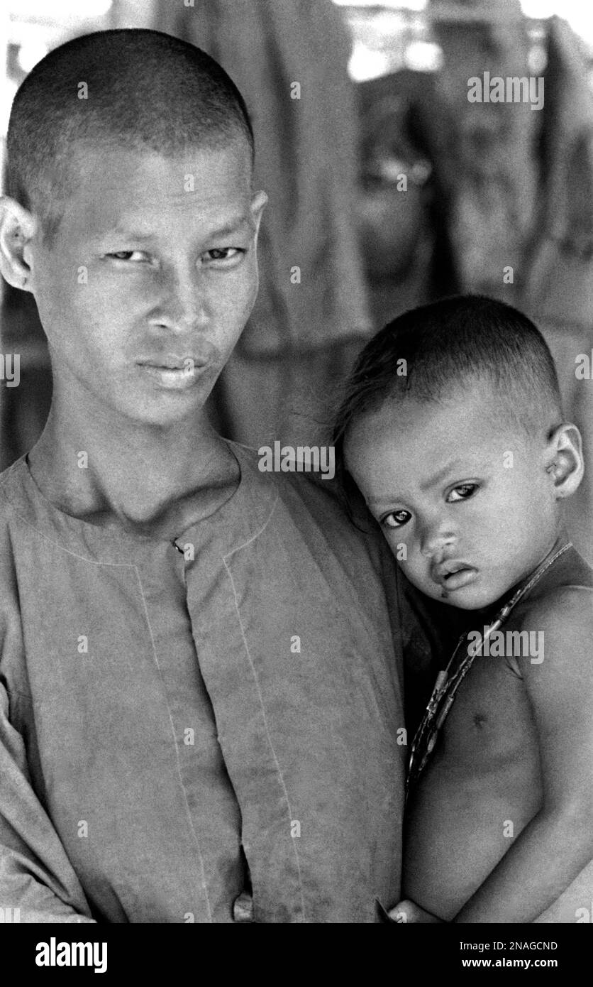 Adults and children at a Phnom Penh refugee camp on March 15, 1975. (AP ...