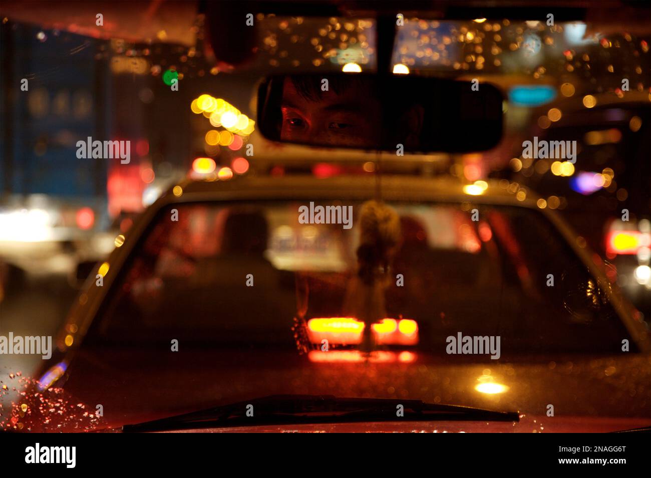 A driver's eyes are reflected in a rear view mirror Stock Photo - Alamy