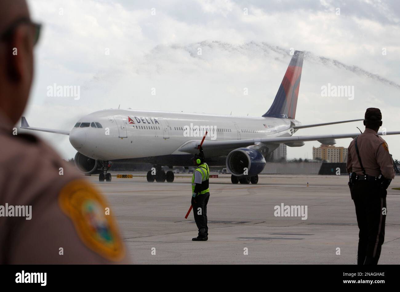 A charter airplane is sprayed with water as the West Virginia NCAA ...