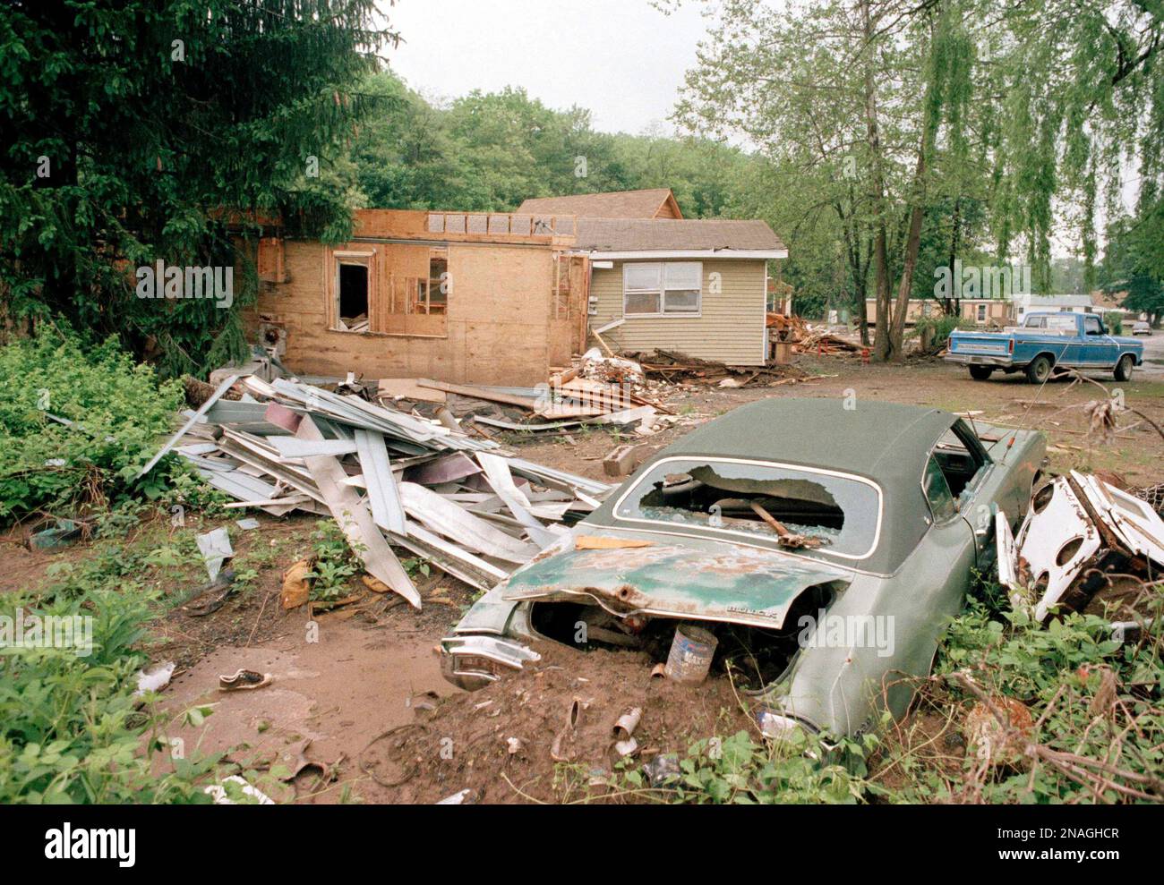 Smashed houses and a car still remain after the disastrous floods in ...