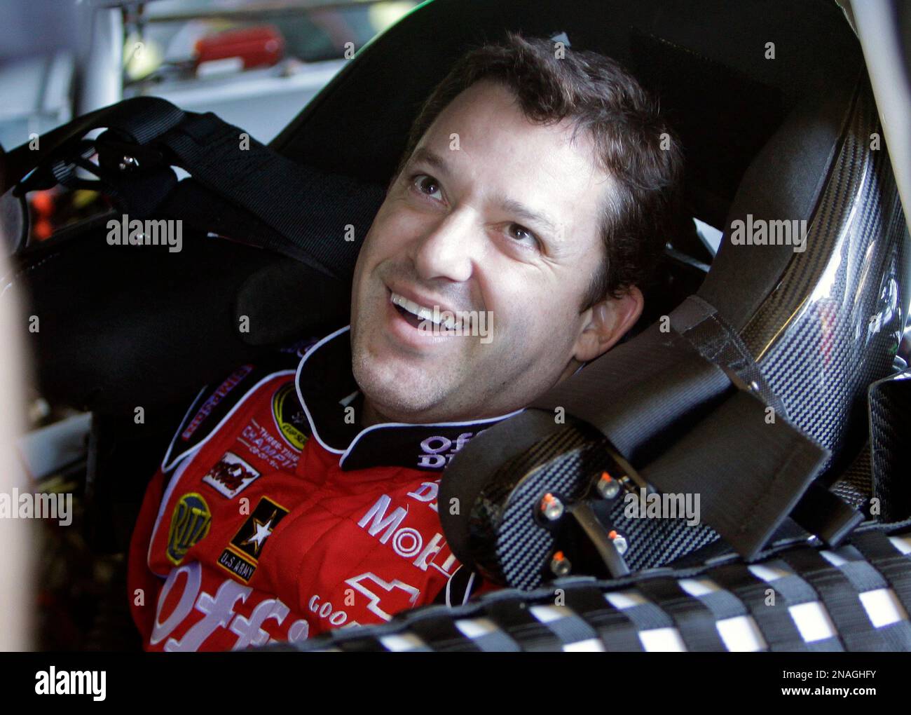 Driver Tony Stewart laughs with members of his crew just before going ...