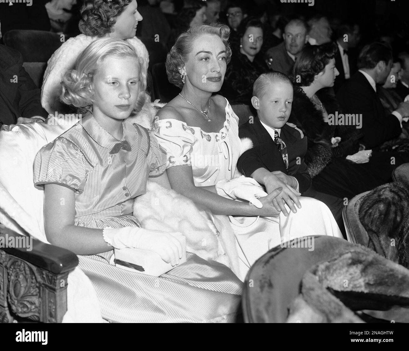 Joan Crawford makes it children's night, at a movie premiere in ...