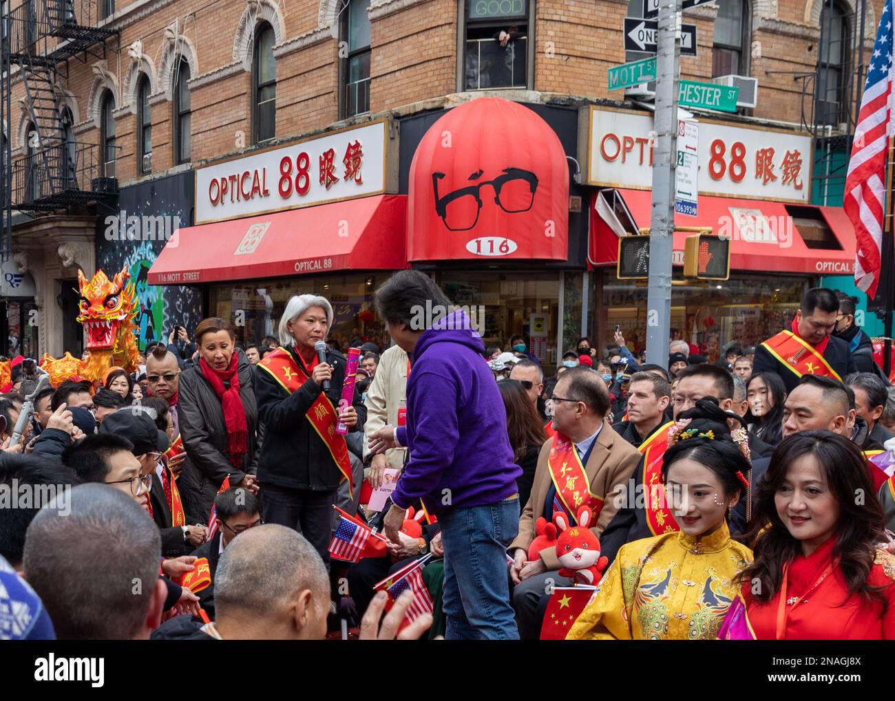 A crowd of people gathered in the streets, celebrating and waving ...
