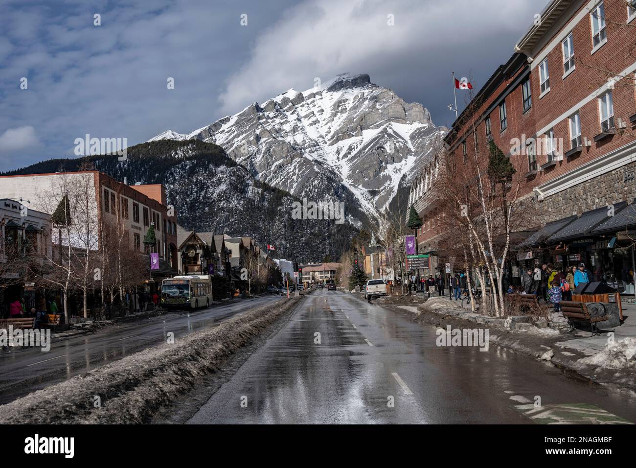 Tourists enjoy visiting retail stores and a view of the mountains from ...