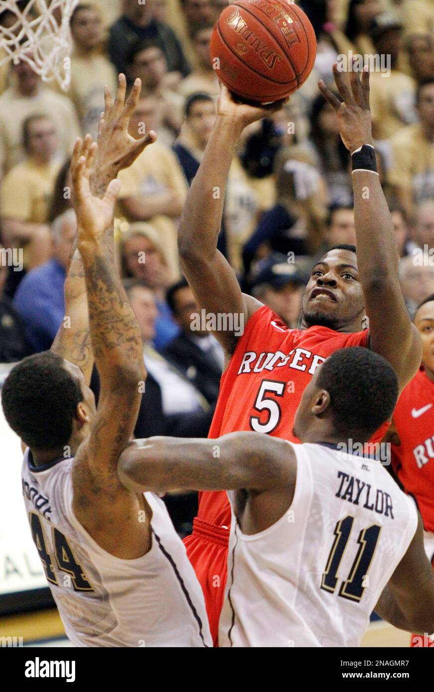 Rutgers' Eli Carter (5) shoots over Pittsburgh's Dante Taylor (11) and ...