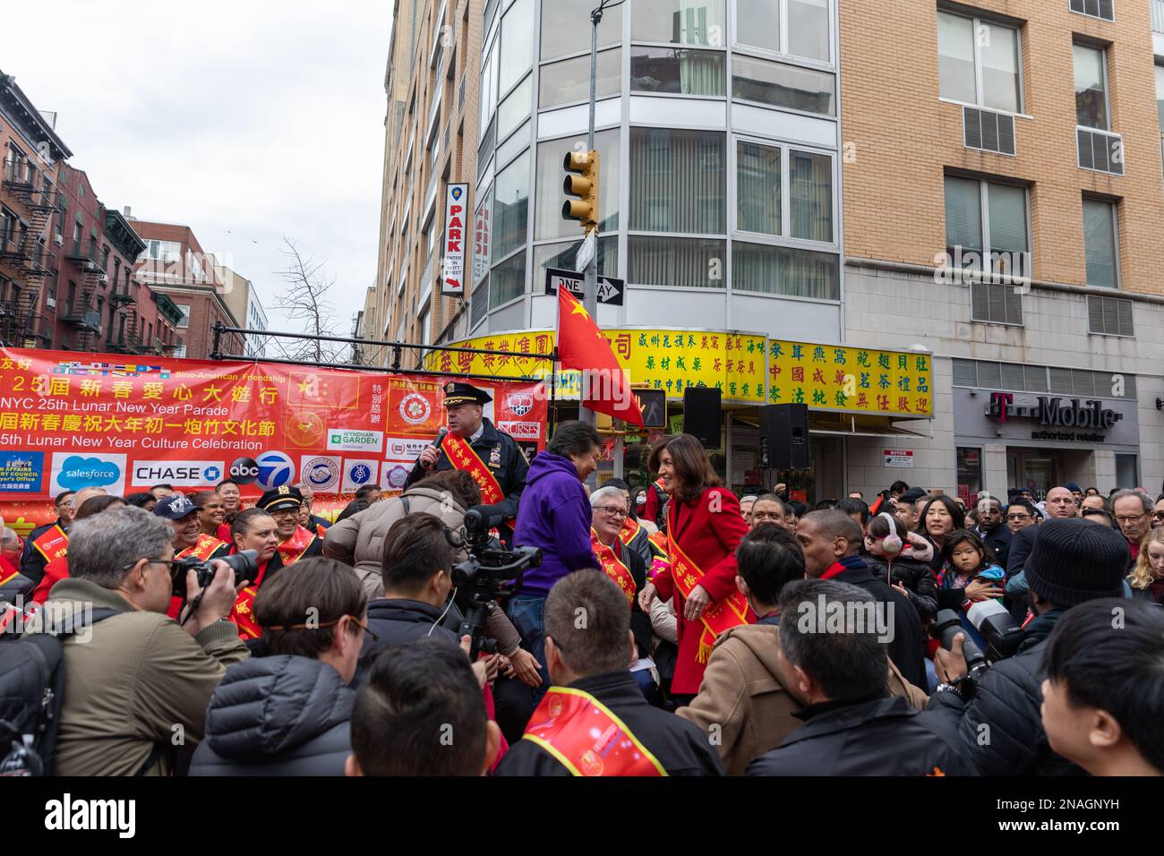 A group of people gathering together with flags and talking to each ...