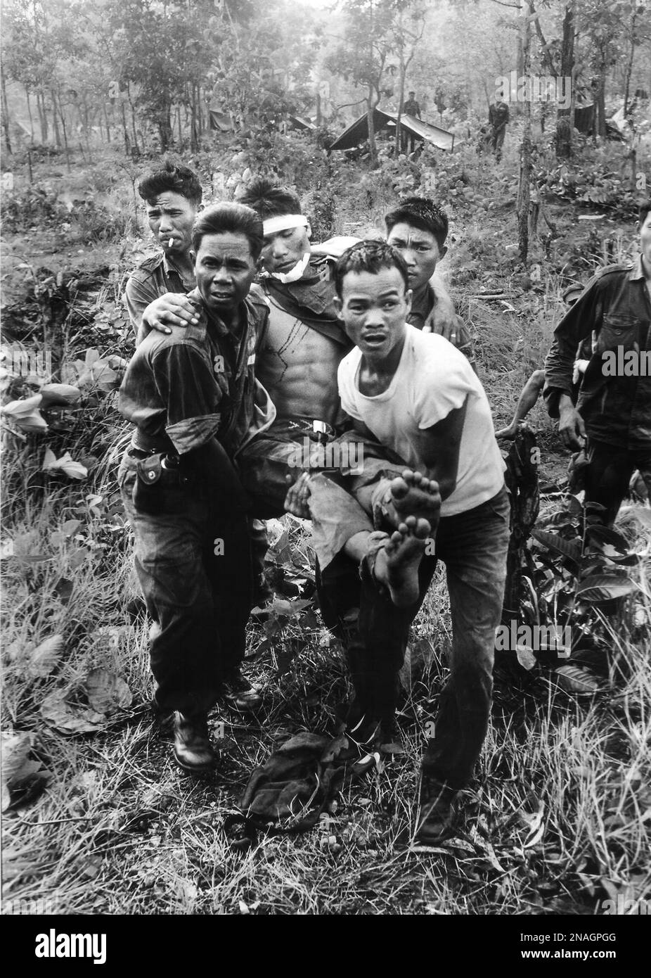 South Vietnamese soldiers carry a wounded comrade after fierce fighting ...