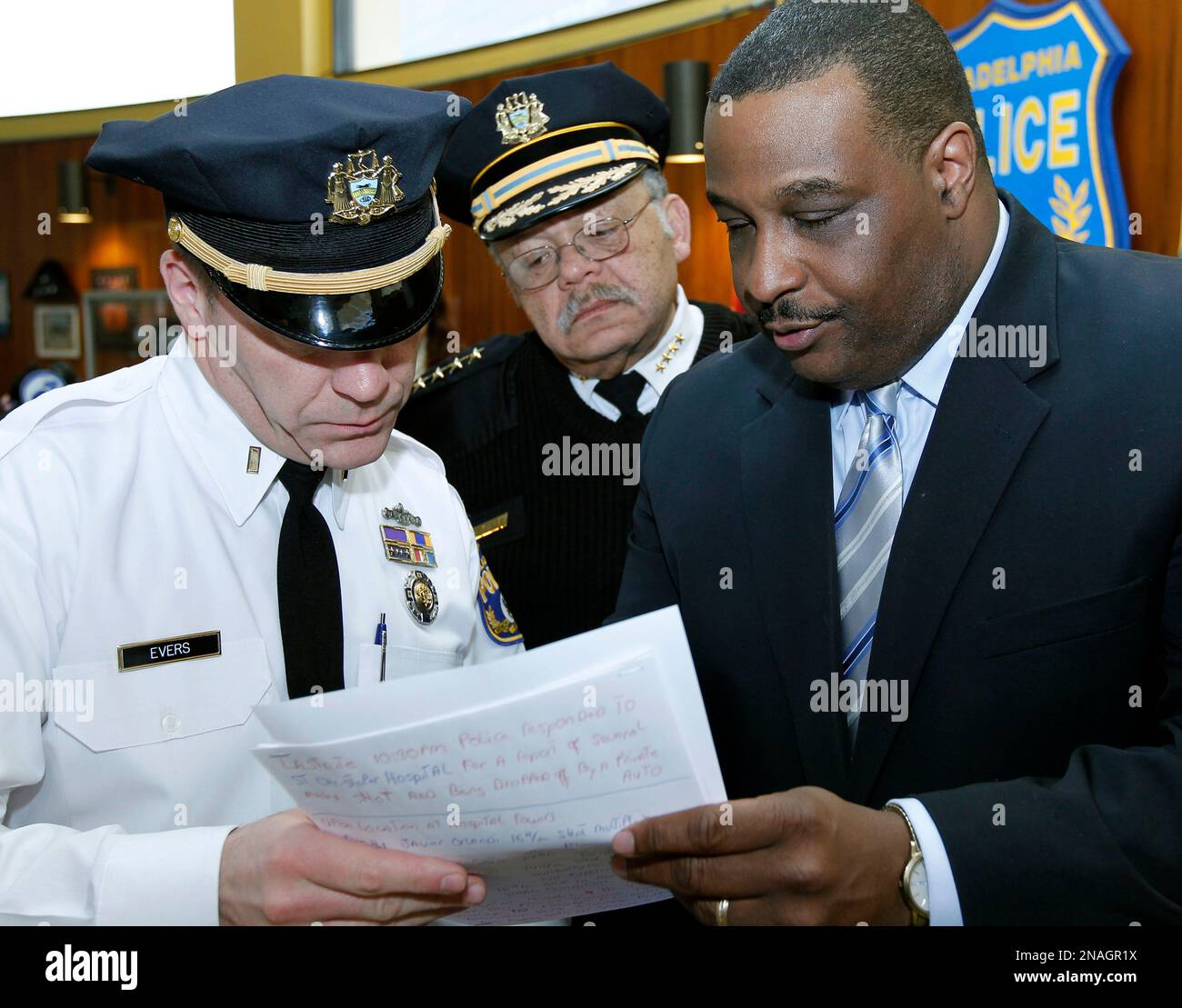Philadelphia Police Lt. Raymond Evers, left, looks a some notes with ...