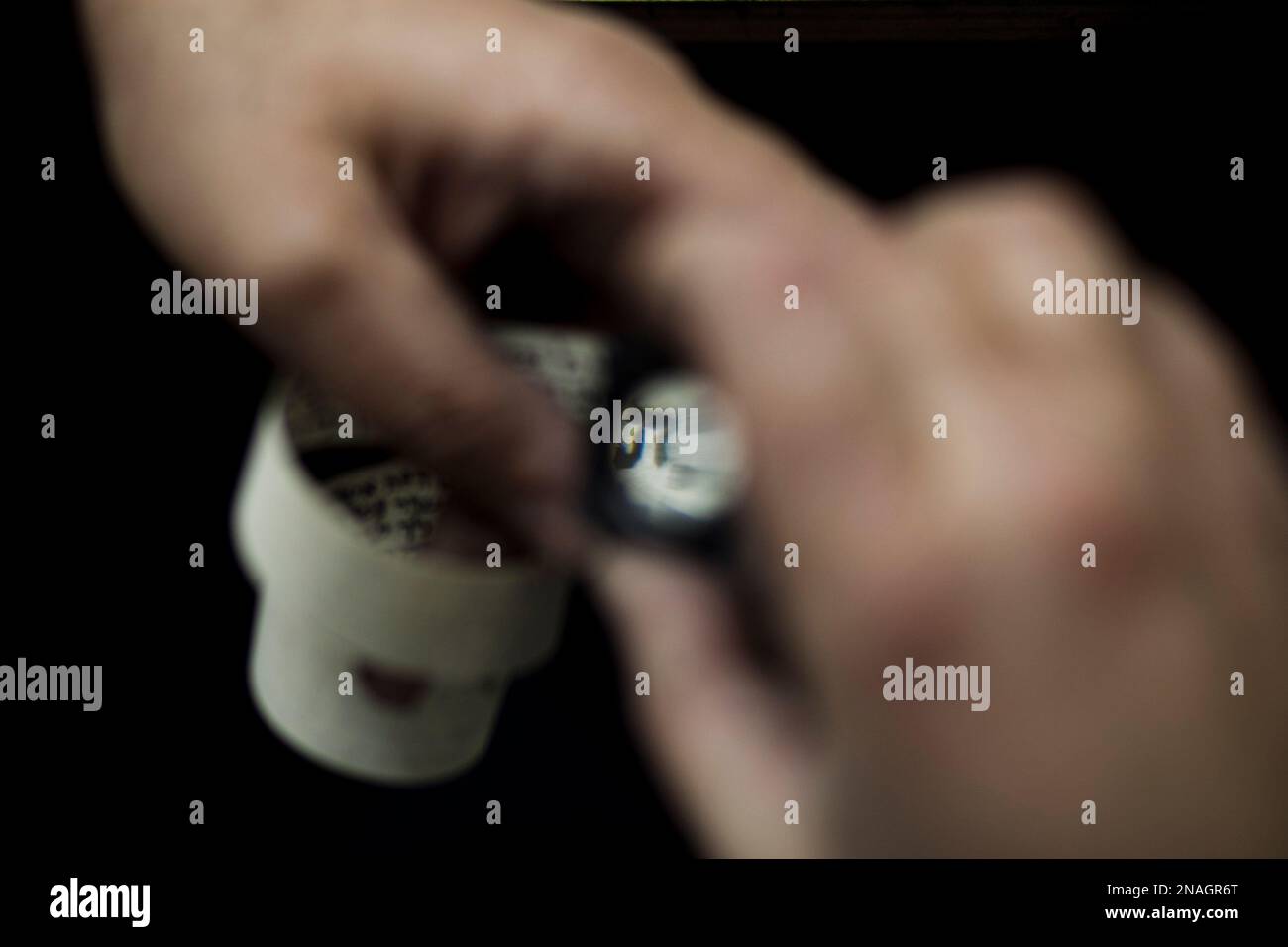 An Ultra Orthodox Jewish man uses a magnifying glass to check a ...