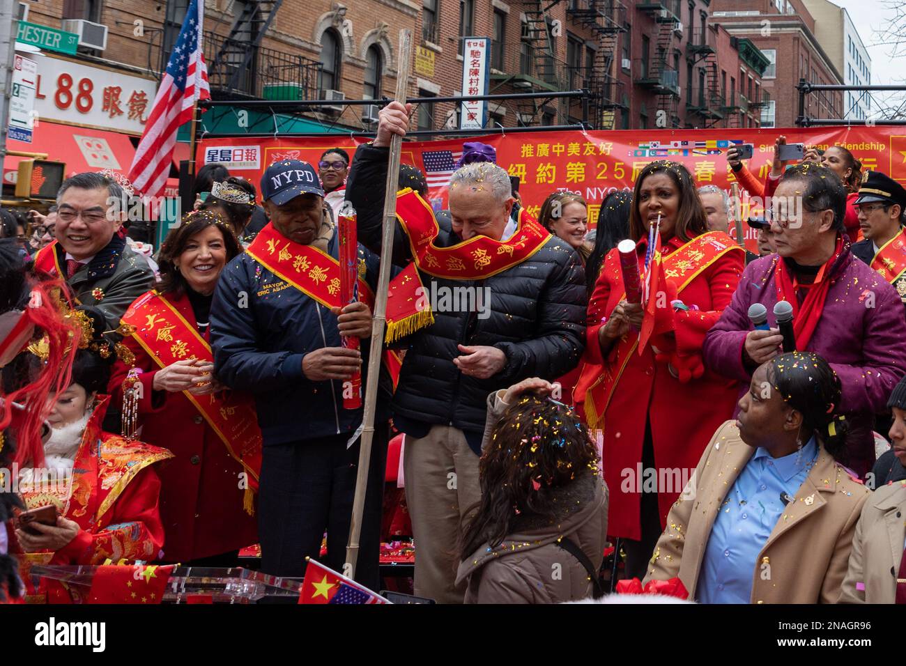 A group of people gathered at the parade on a city street under ...
