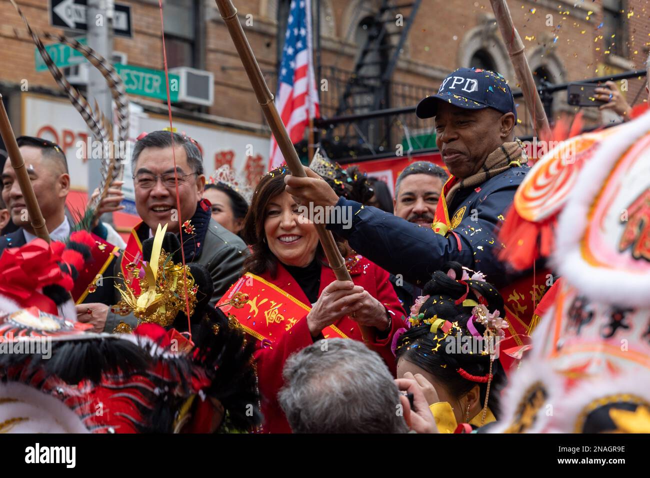 A group of people walking down a street in a celebratory parade ...