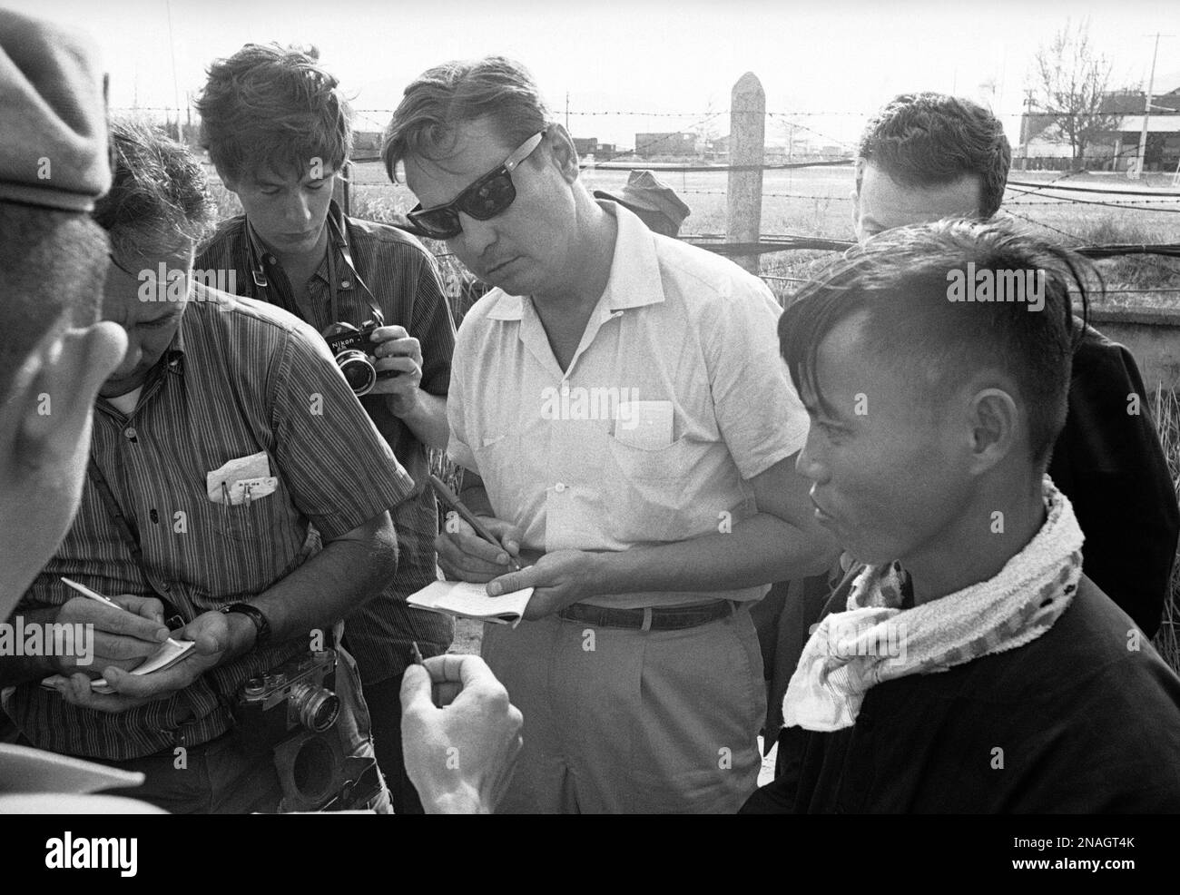Reporters during the Vietnam War. Viet Cong at right. Location and date ...