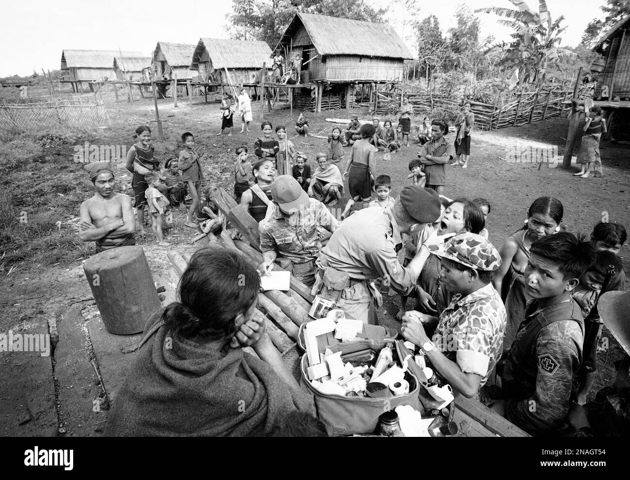 Aid workers examining villagers during the Vietnam War. Location and ...