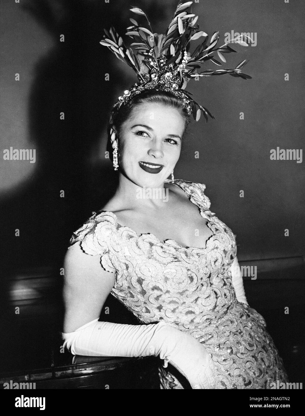 French actress Denise Darcel wears a crown of olive branches, symbol of ...