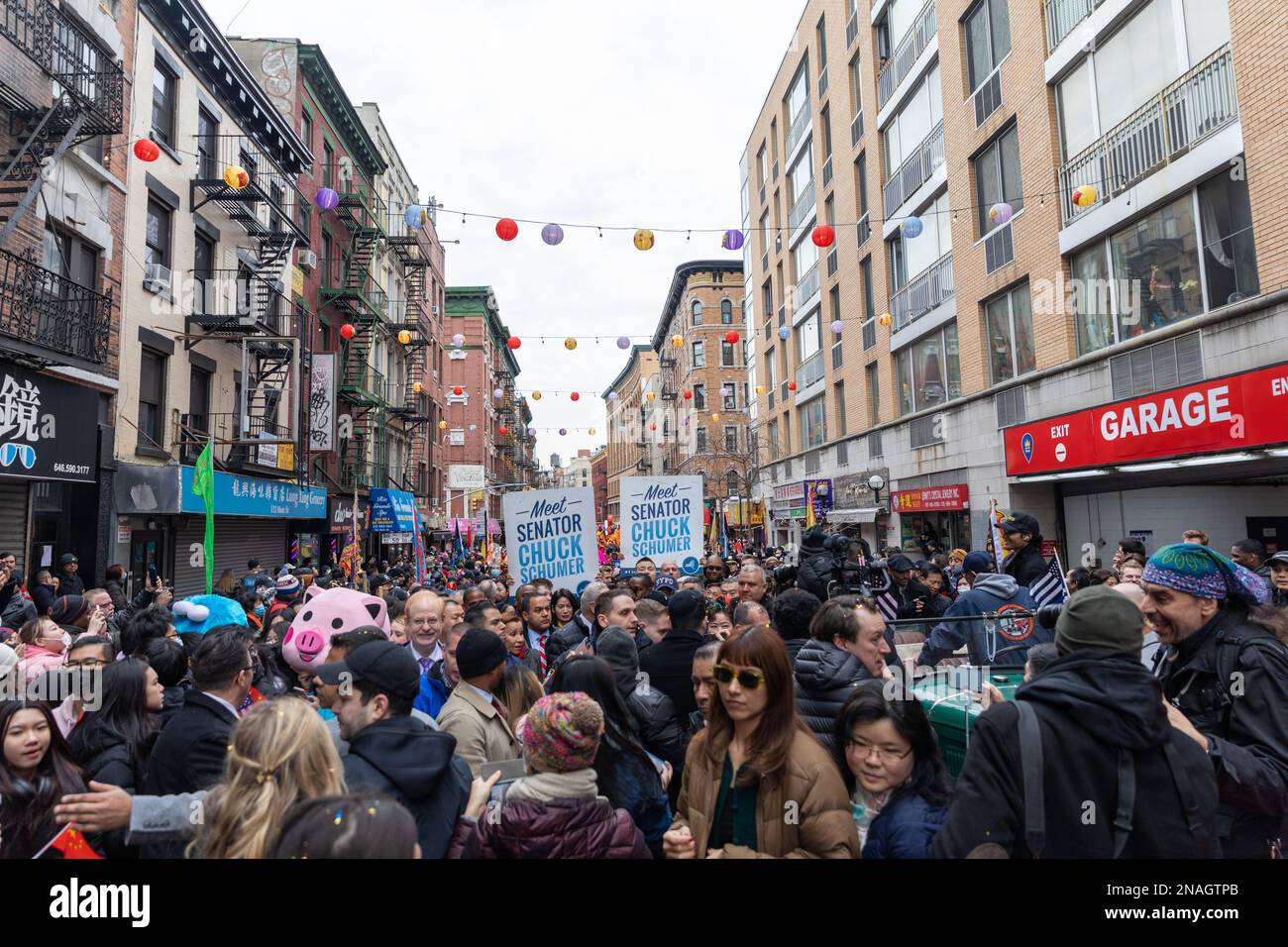 A group of people standing on a busy street with a multitude of flags ...