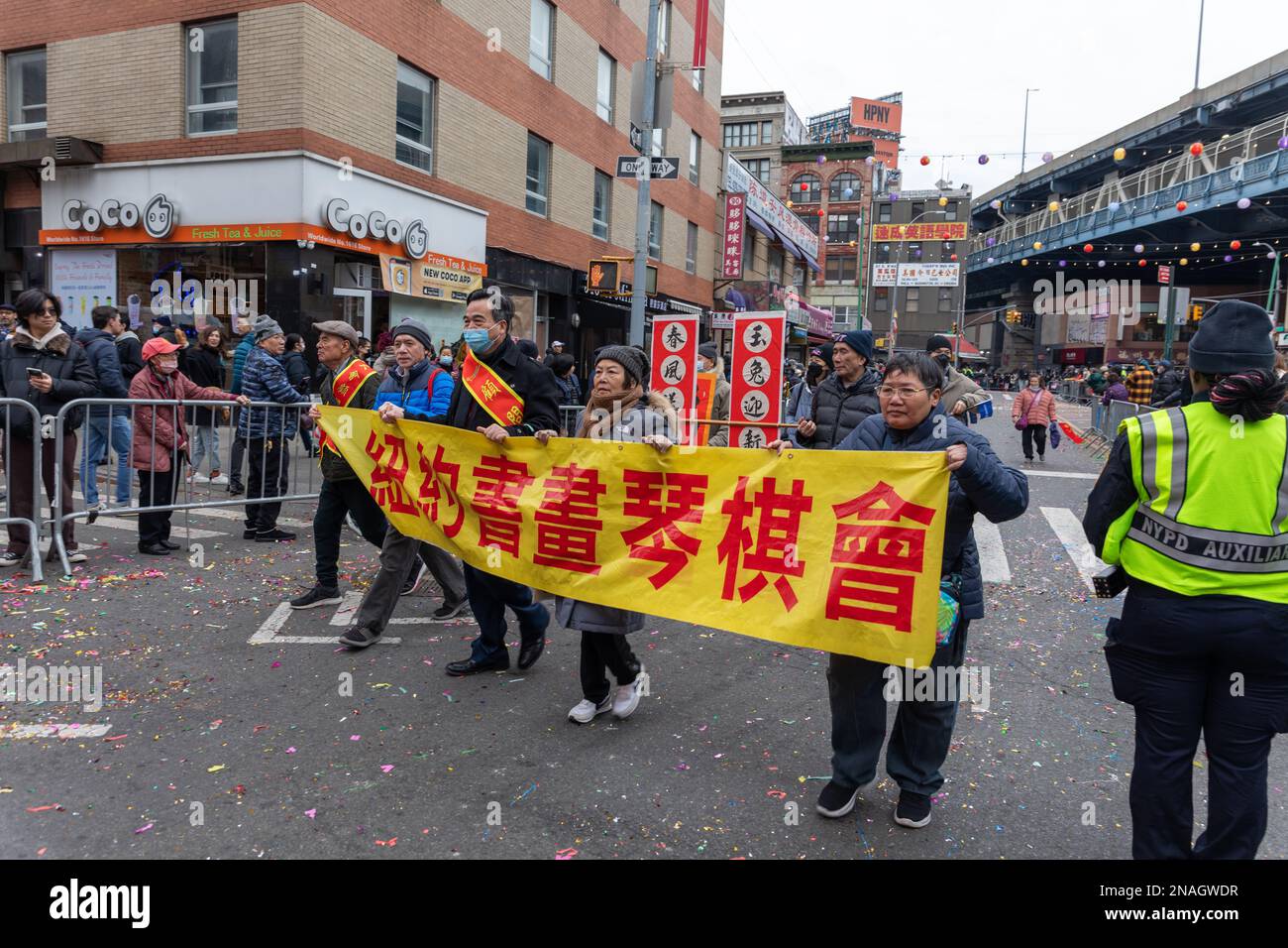 A group of people walking with a large yellow sign during a Chinese ...