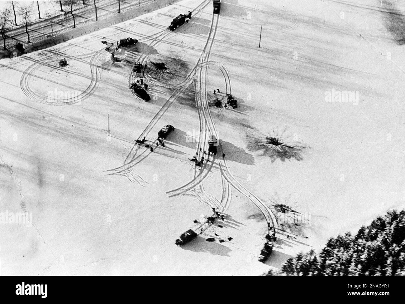 The vehicles of an Allied platoon halt in a snow-covered field, in the ...