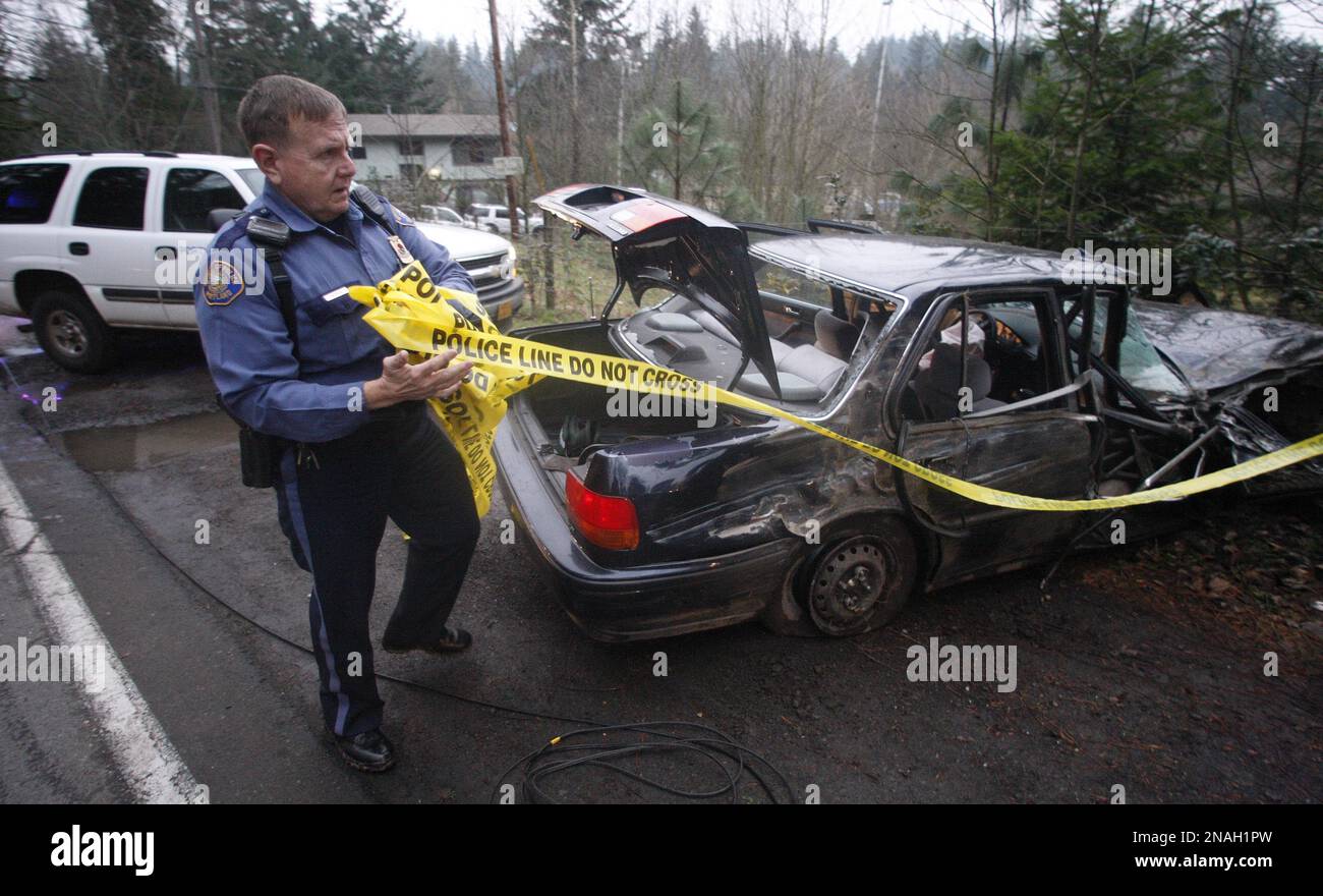 Portland police officer Dave Norlin takes down crime scene tape from ...
