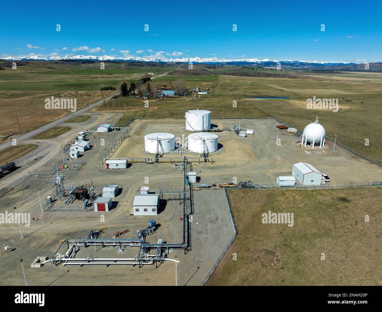 Aerial view of large round metal oil storage tanks with pipelines ...