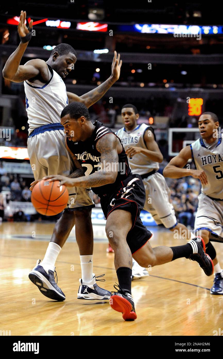 Cincinnati's Sean Kilpatrick drives past Georgetown's Henry Sims, left ...