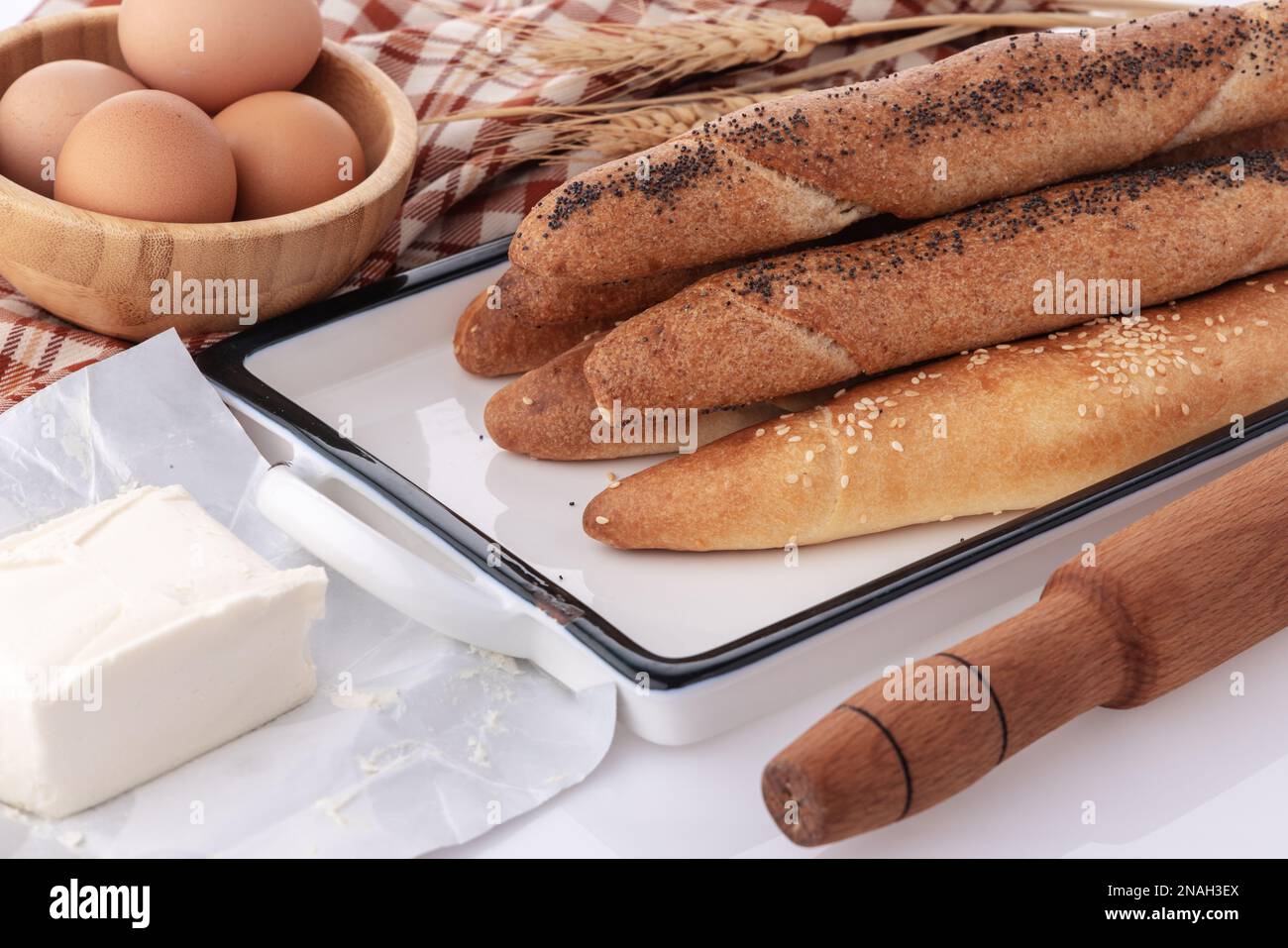 Freshly baked crusty homemade butter rolls or baked horns with eggs and ...