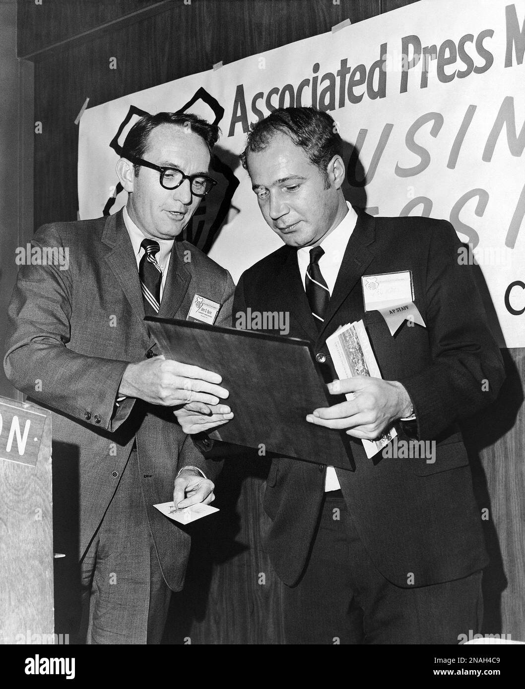 AP photographer Eddie Adams, right, is shown receiving a framed ...