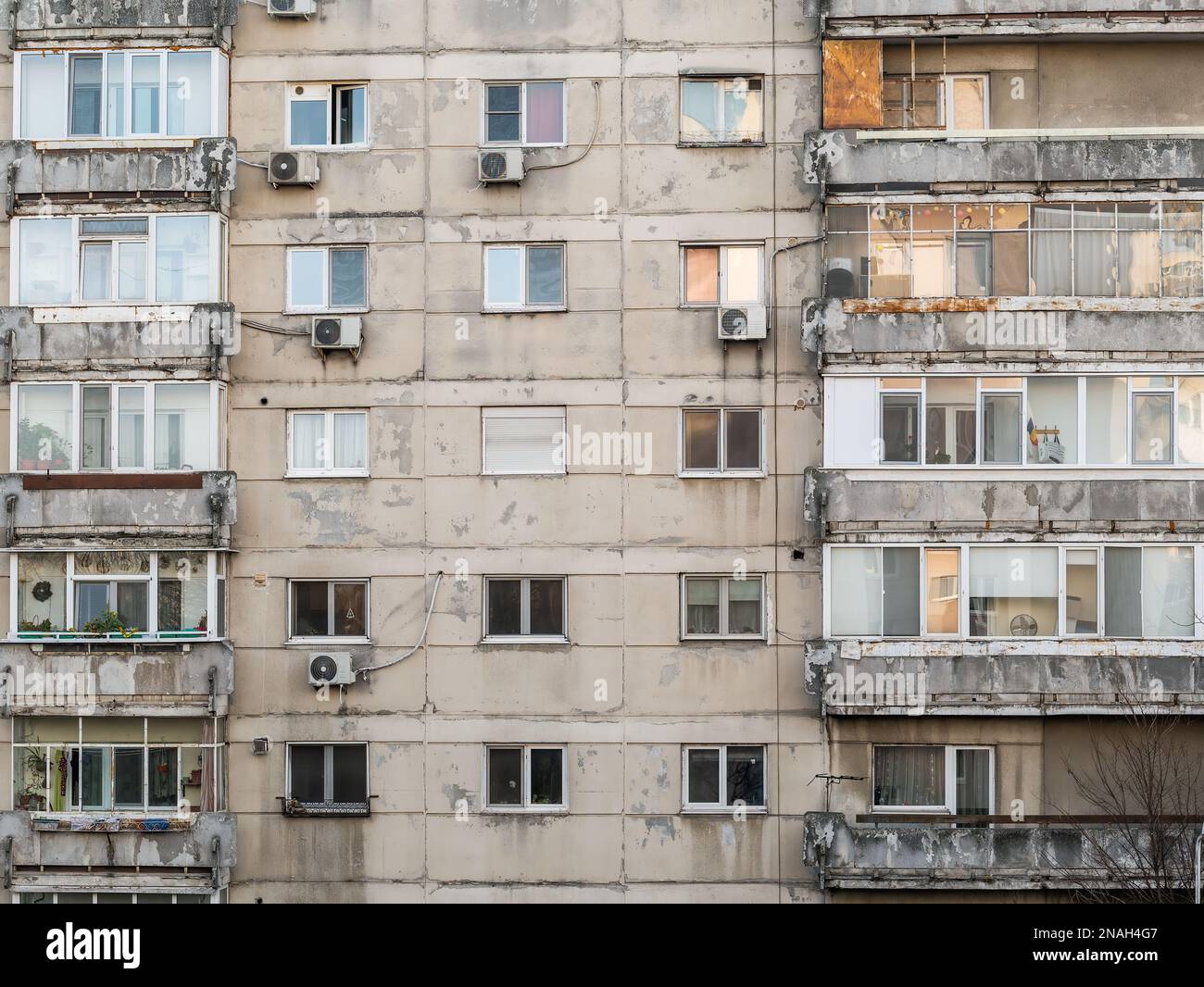 Worn out apartment building from the communist era against blue sky in ...