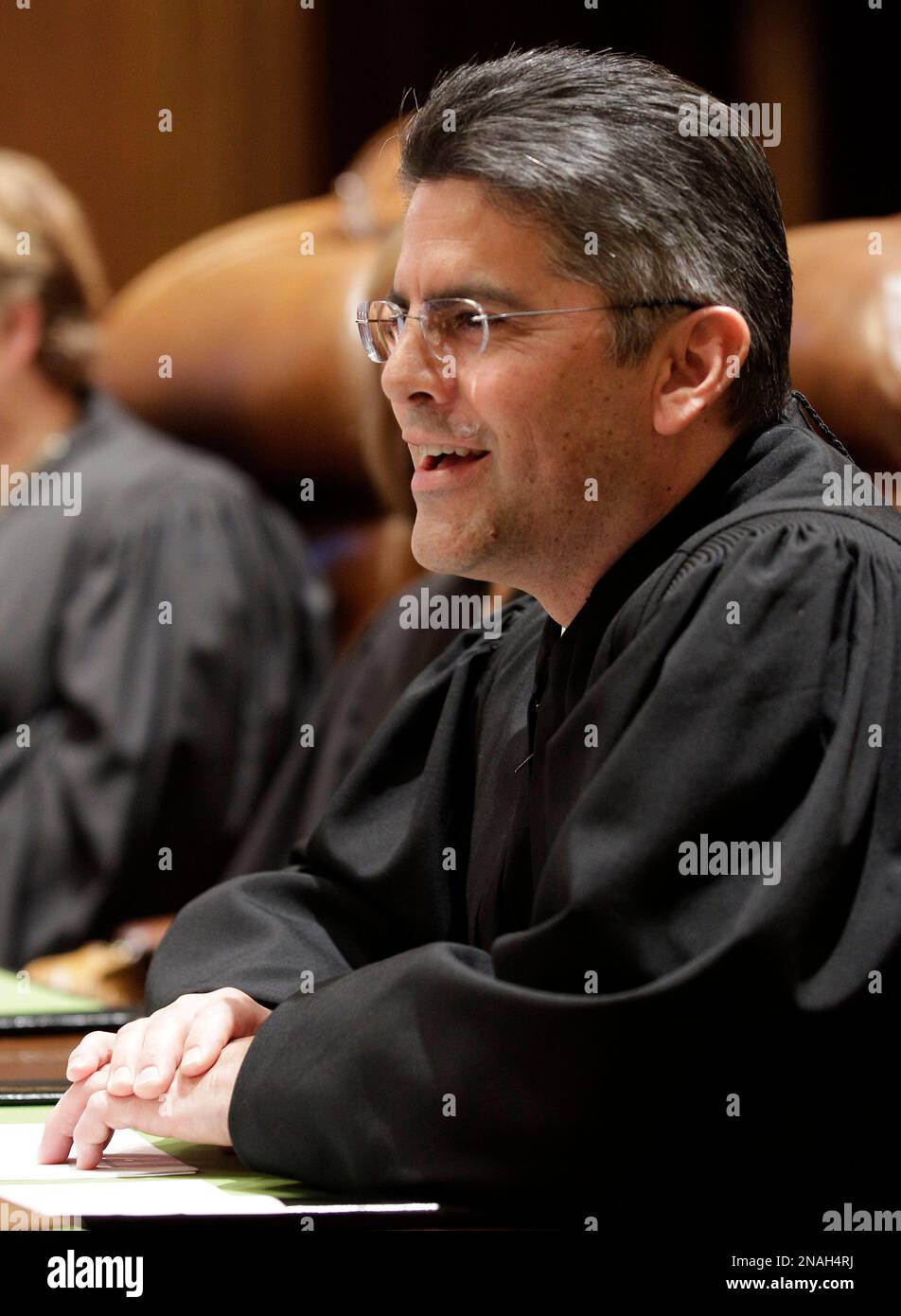 Steven Gonzalez sits on the bench after he was sworn in as the newest ...
