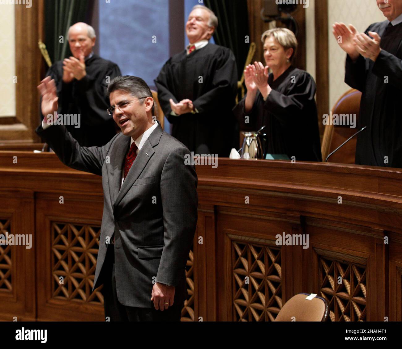 Steven Gonzalez, second from left, waves acknowledging applause after ...