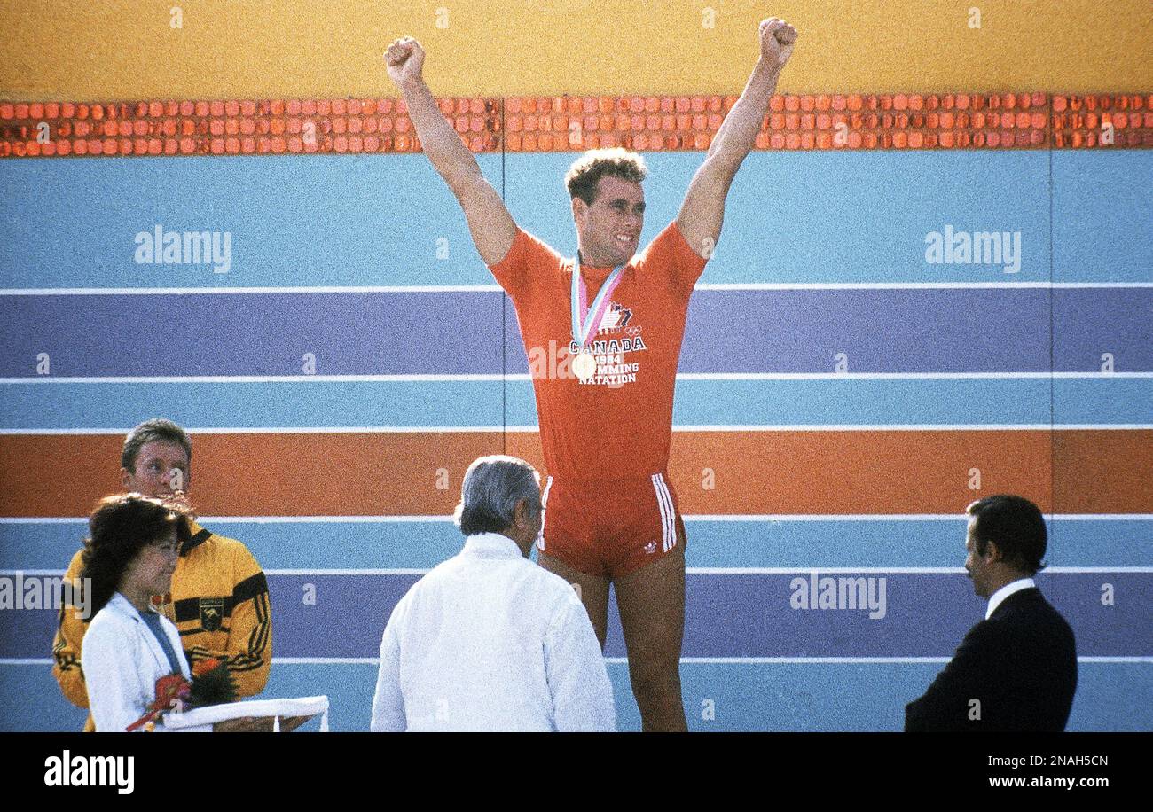 Canadian swimmer Victor Davis, with arms raised, celebrates winning the ...