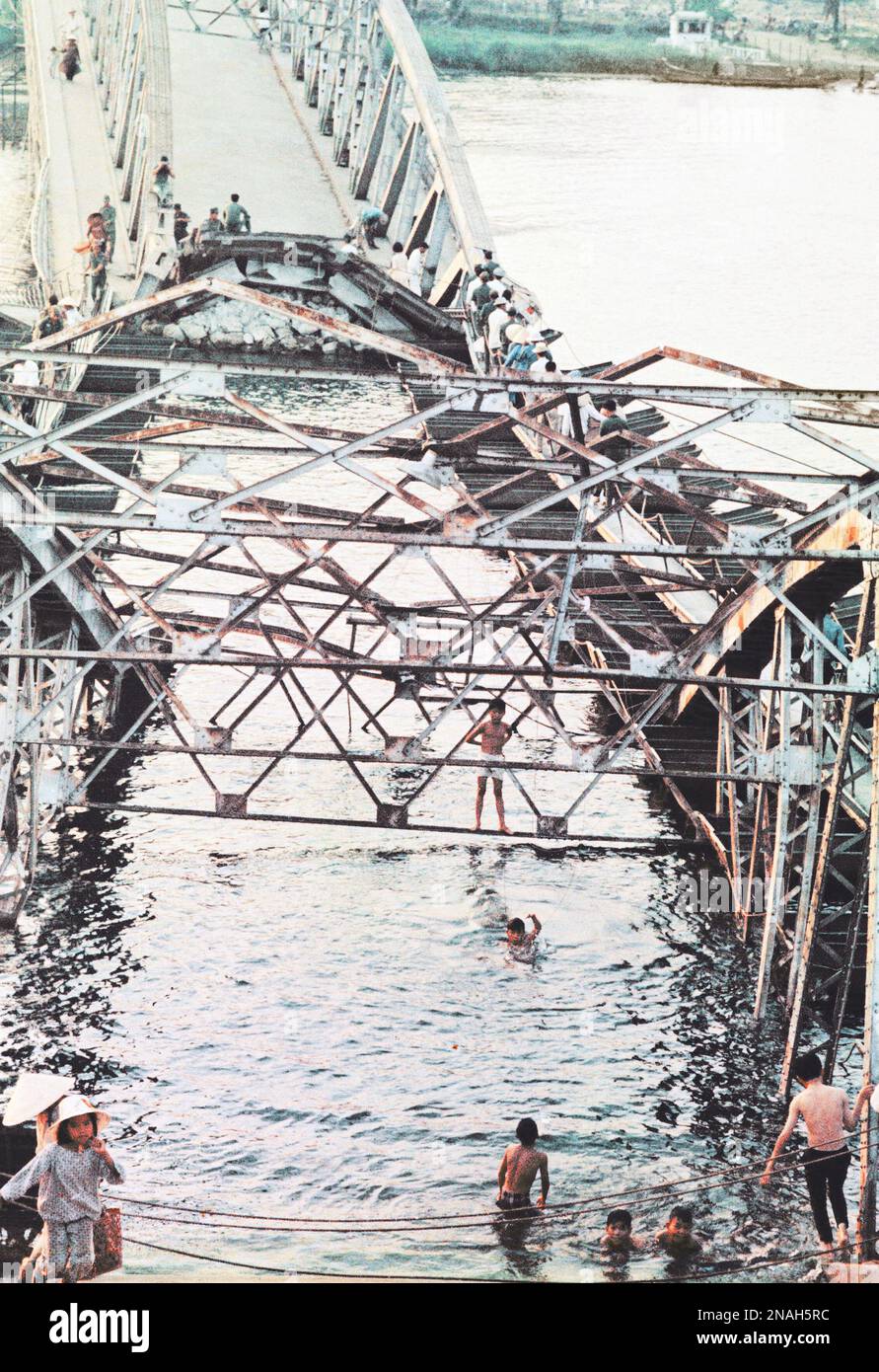 People use a section of the Hue bridge's destroyed framework as a ...