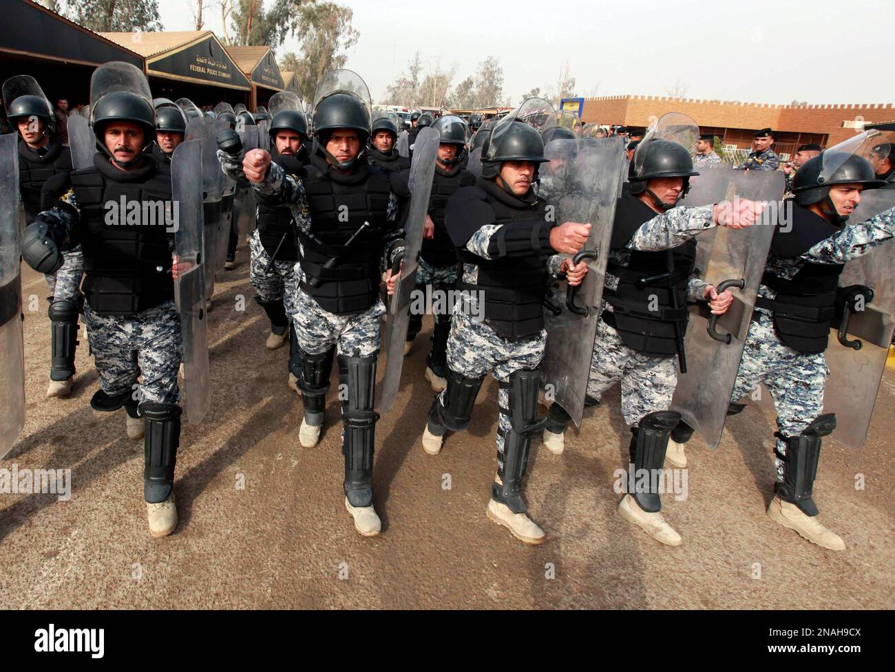 Iraqi riot police march during a graduation ceremony in Baghdad, Iraq ...